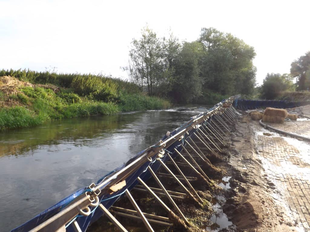 Channel diversion using a portadam temporary dam system - OnSite - OnSite