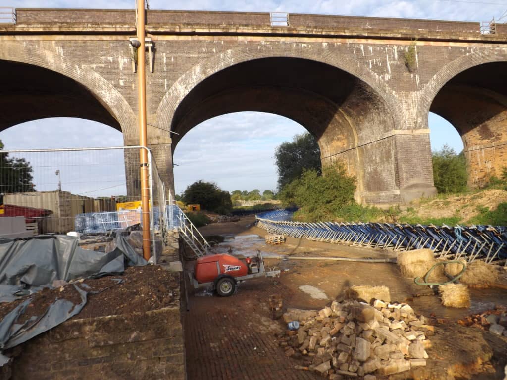 Channel diversion using a portadam temporary dam system - OnSite - OnSite