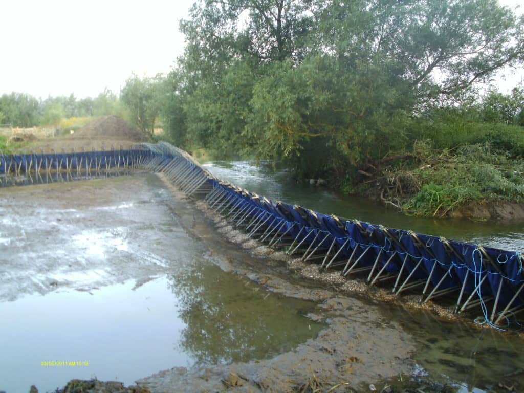 Channel diversion using a portadam temporary dam system - OnSite - OnSite