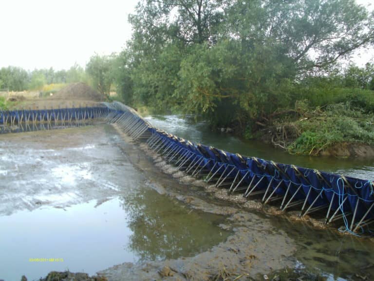 Channel diversion using a portadam temporary dam system - OnSite - OnSite